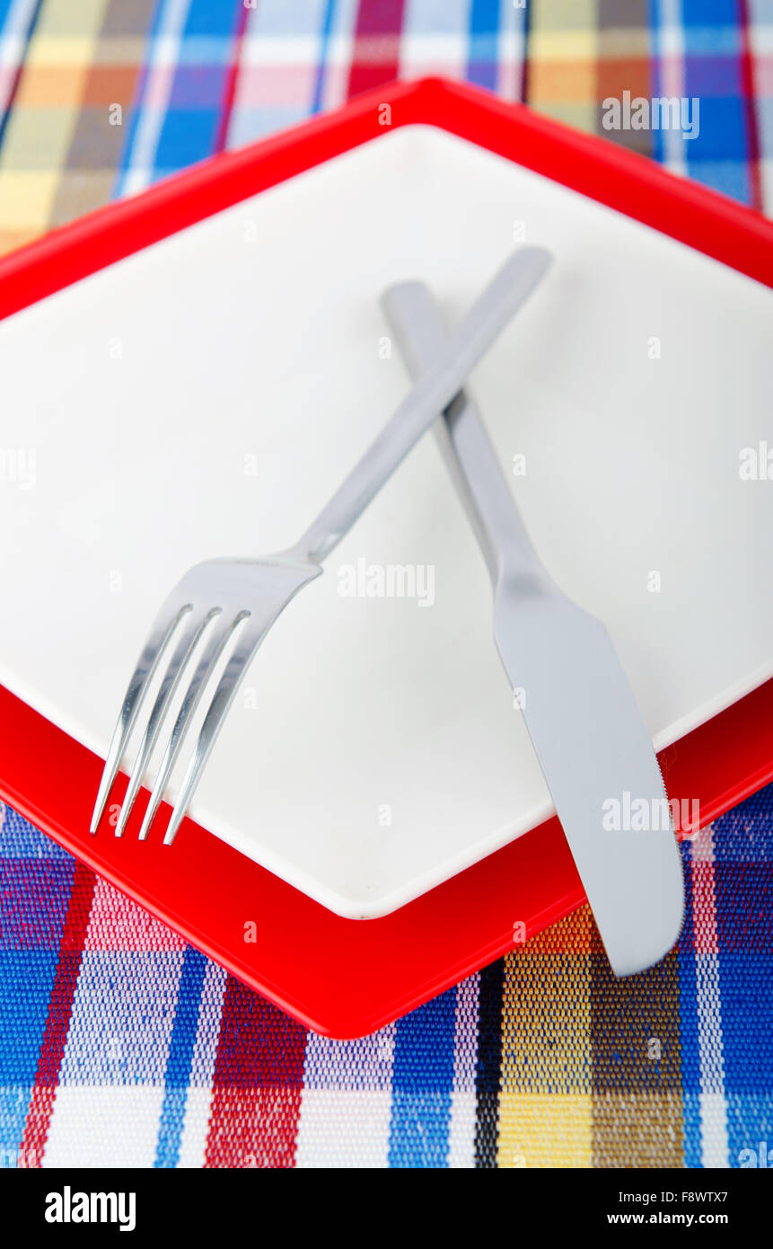 Empty plate with utensils Stock Photo - Alamy