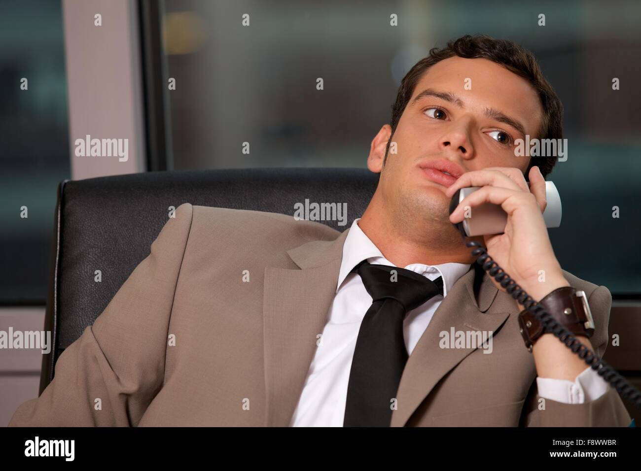 Businessman using telephone in an office Stock Photo - Alamy