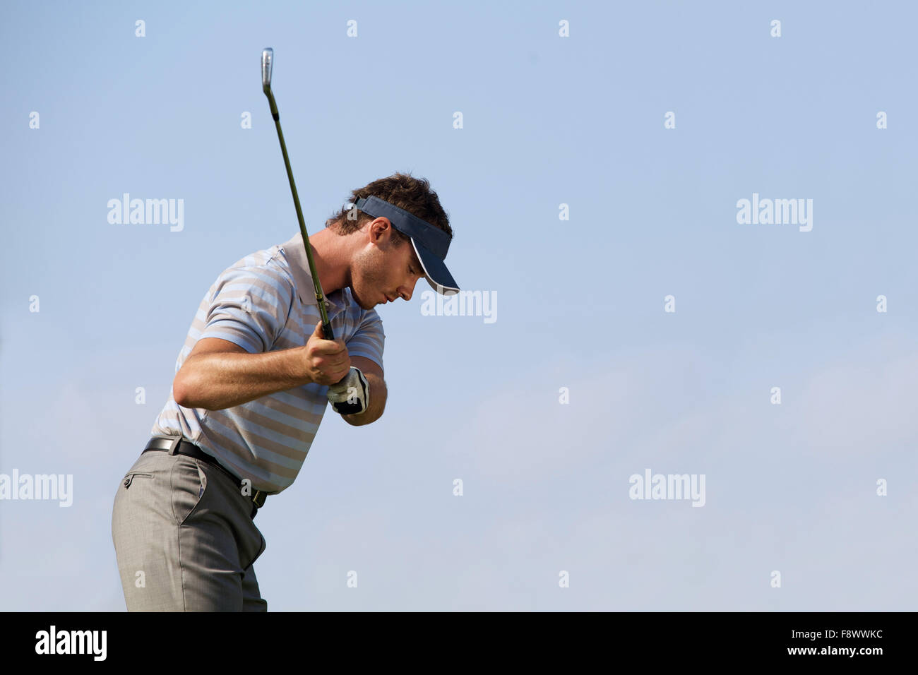 Young man playing golf Stock Photo - Alamy