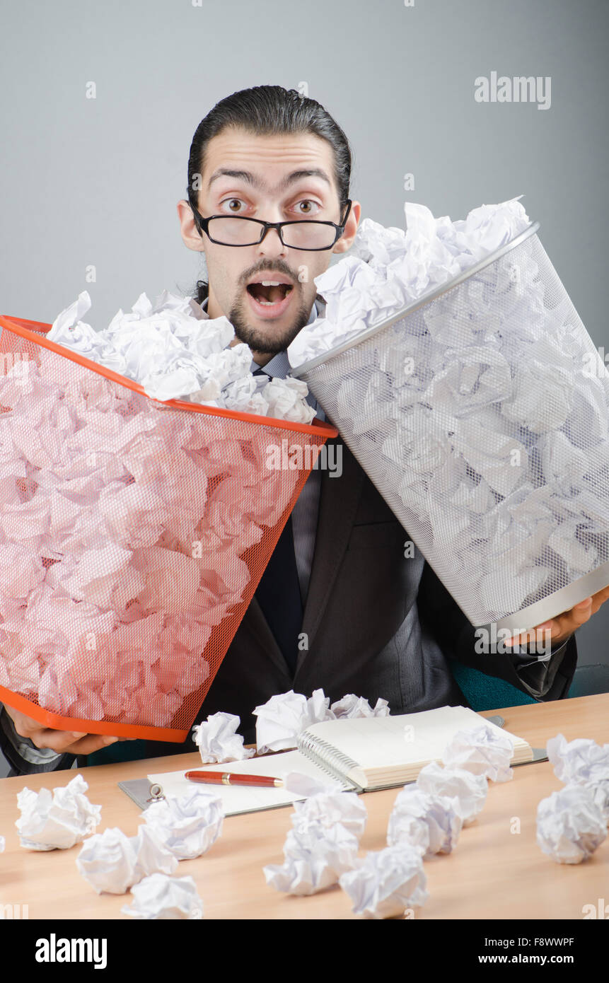 Man with lots of wasted paper Stock Photo - Alamy