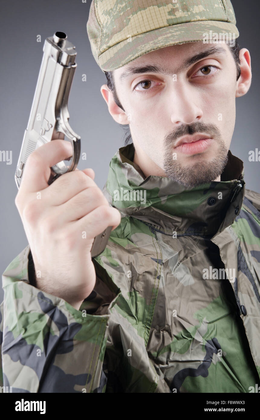 Soldier with gun in studio shooting Stock Photo - Alamy