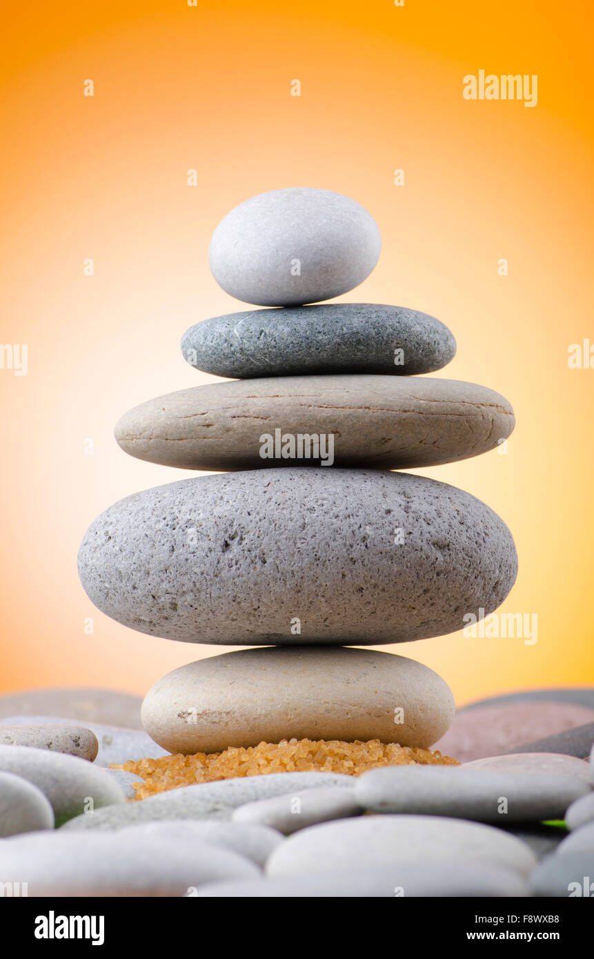 Balanced pebbles with colour background Stock Photo - Alamy
