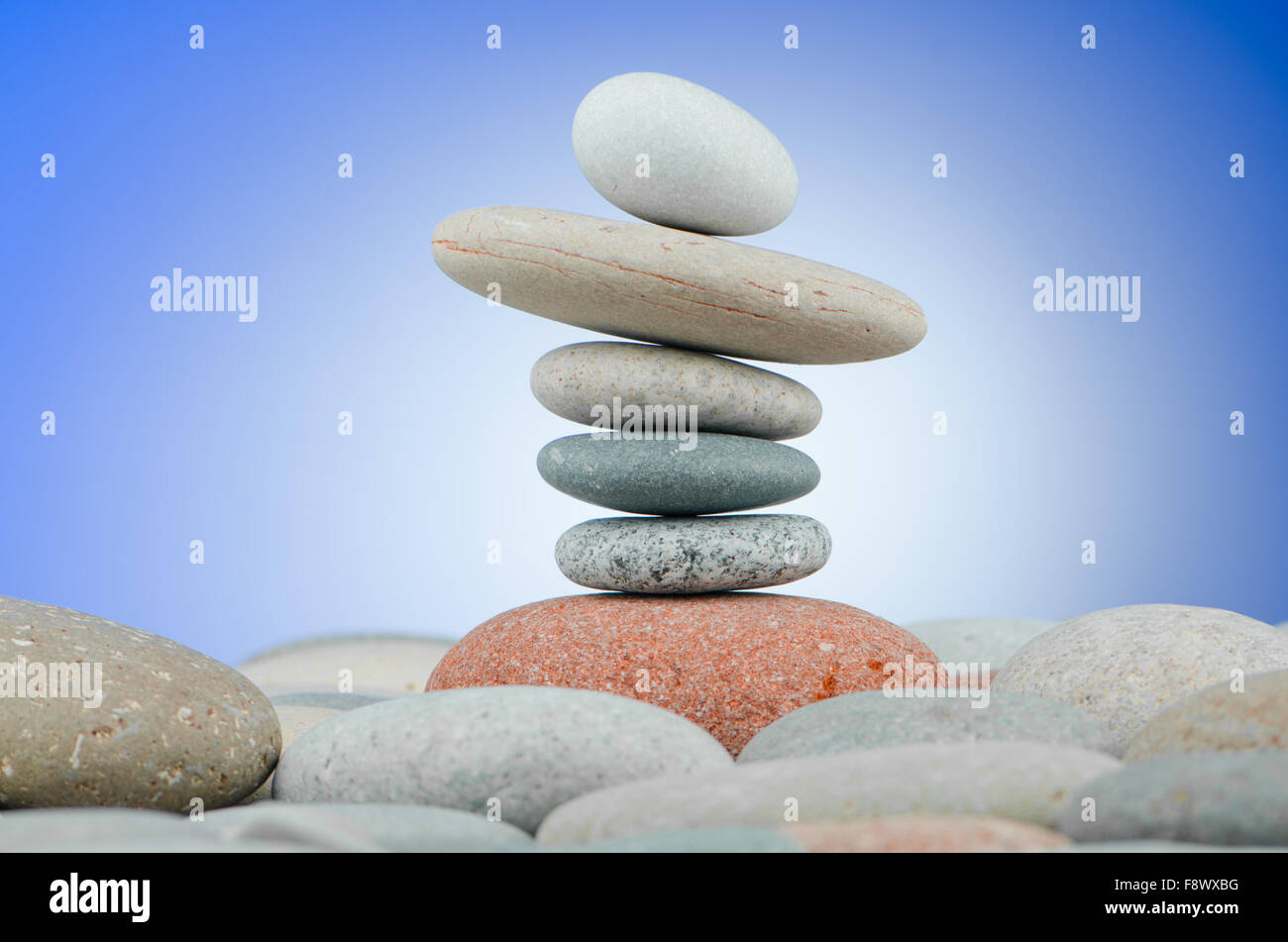 Pebbles stack against gradient background Stock Photo - Alamy