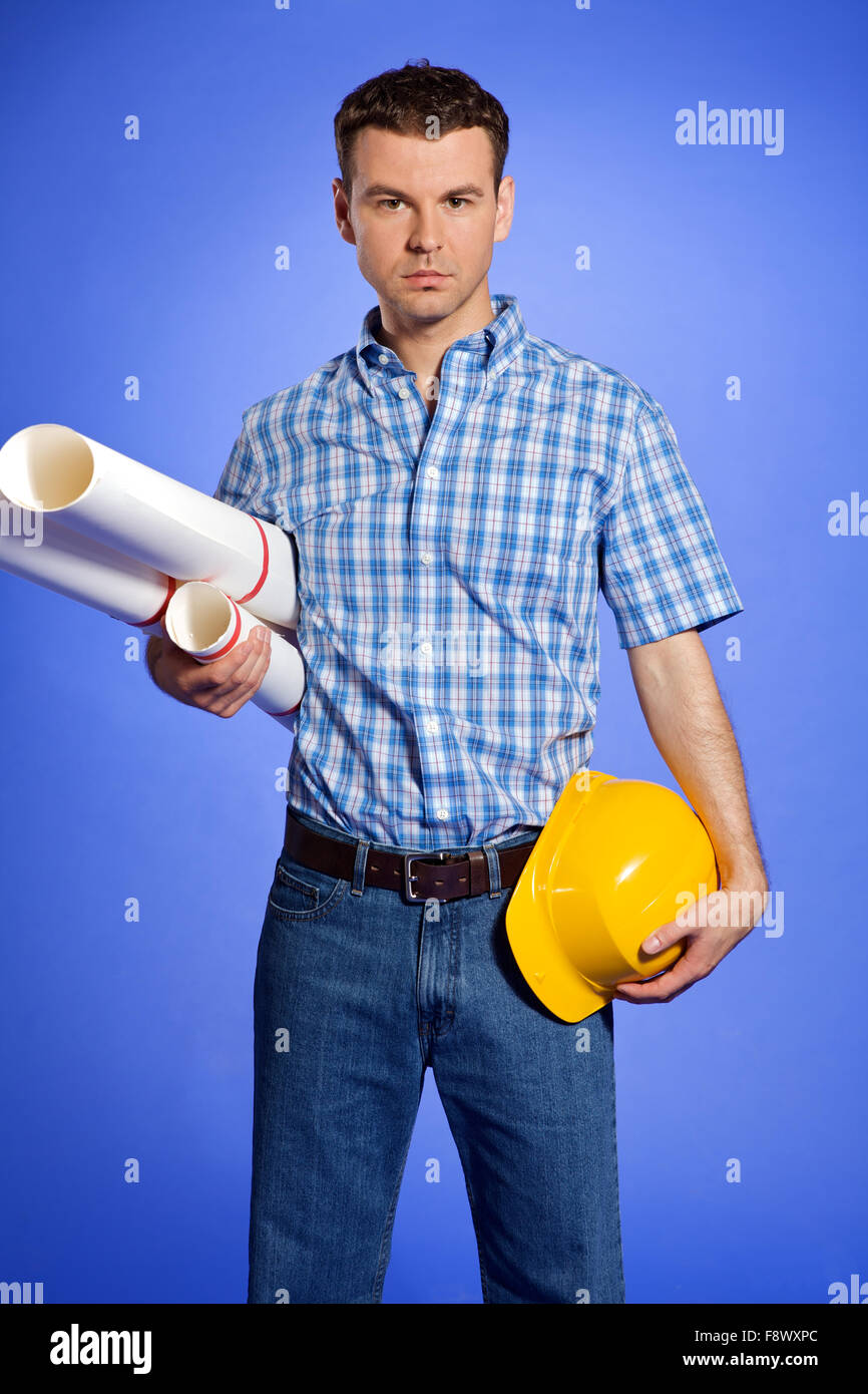 Portrait of architect holding blueprint and hardhat Stock Photo - Alamy