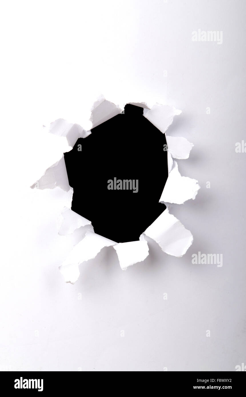 Hole in the white paper Stock Photo - Alamy