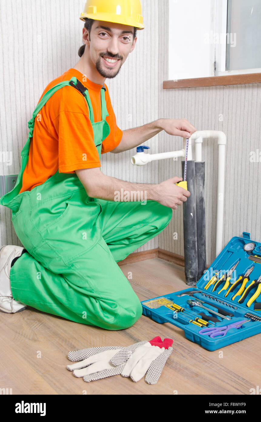 Plumber working in the bathroom Stock Photo - Alamy