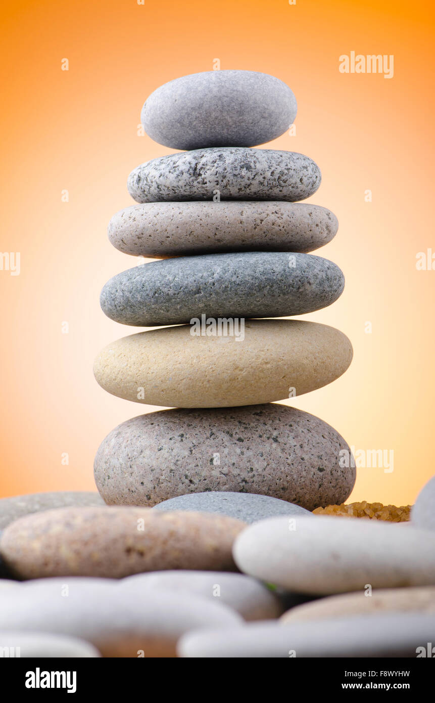 Balanced pebbles with colour background Stock Photo - Alamy