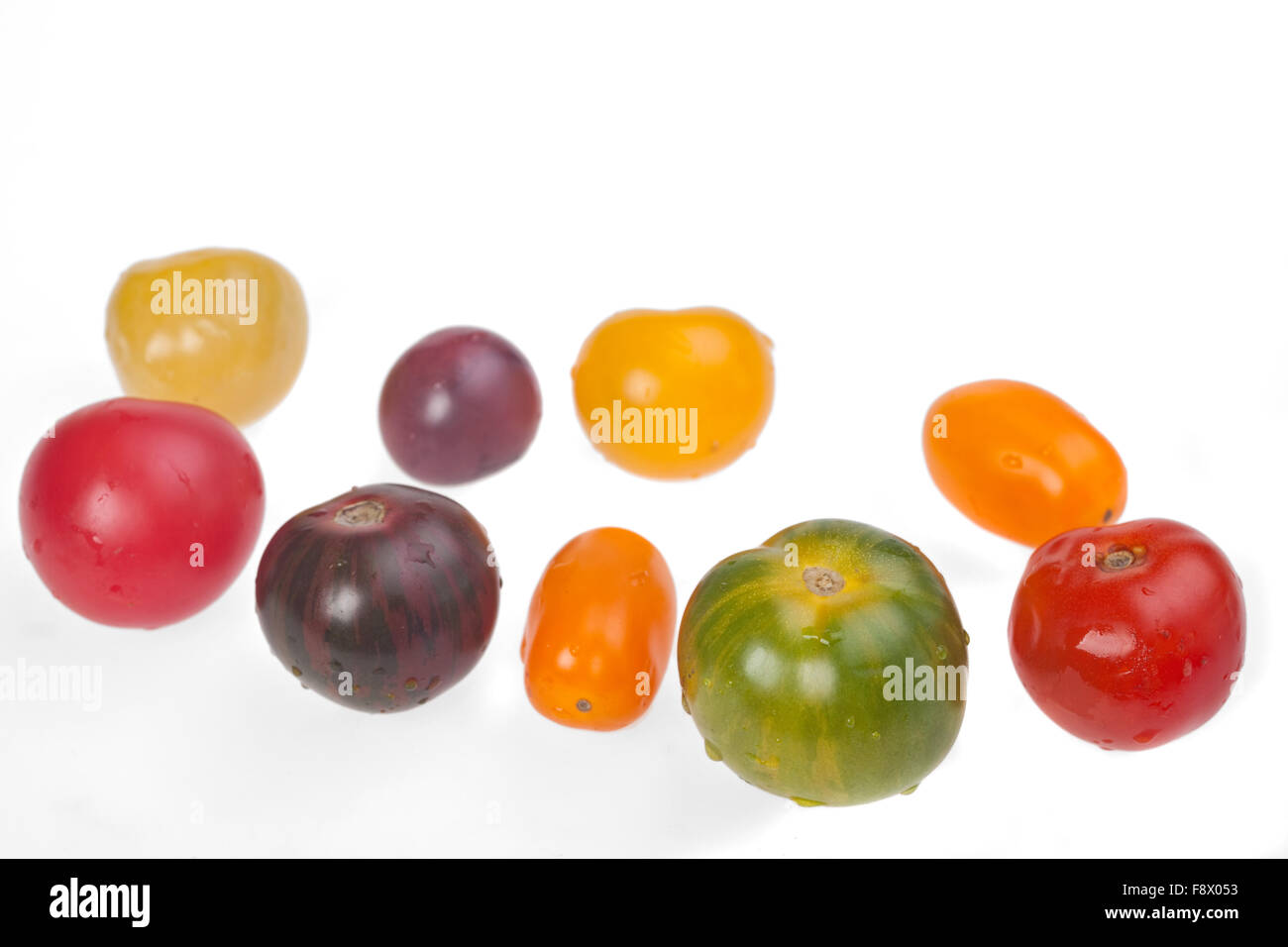 different tomatoes isolated on white background Stock Photo - Alamy