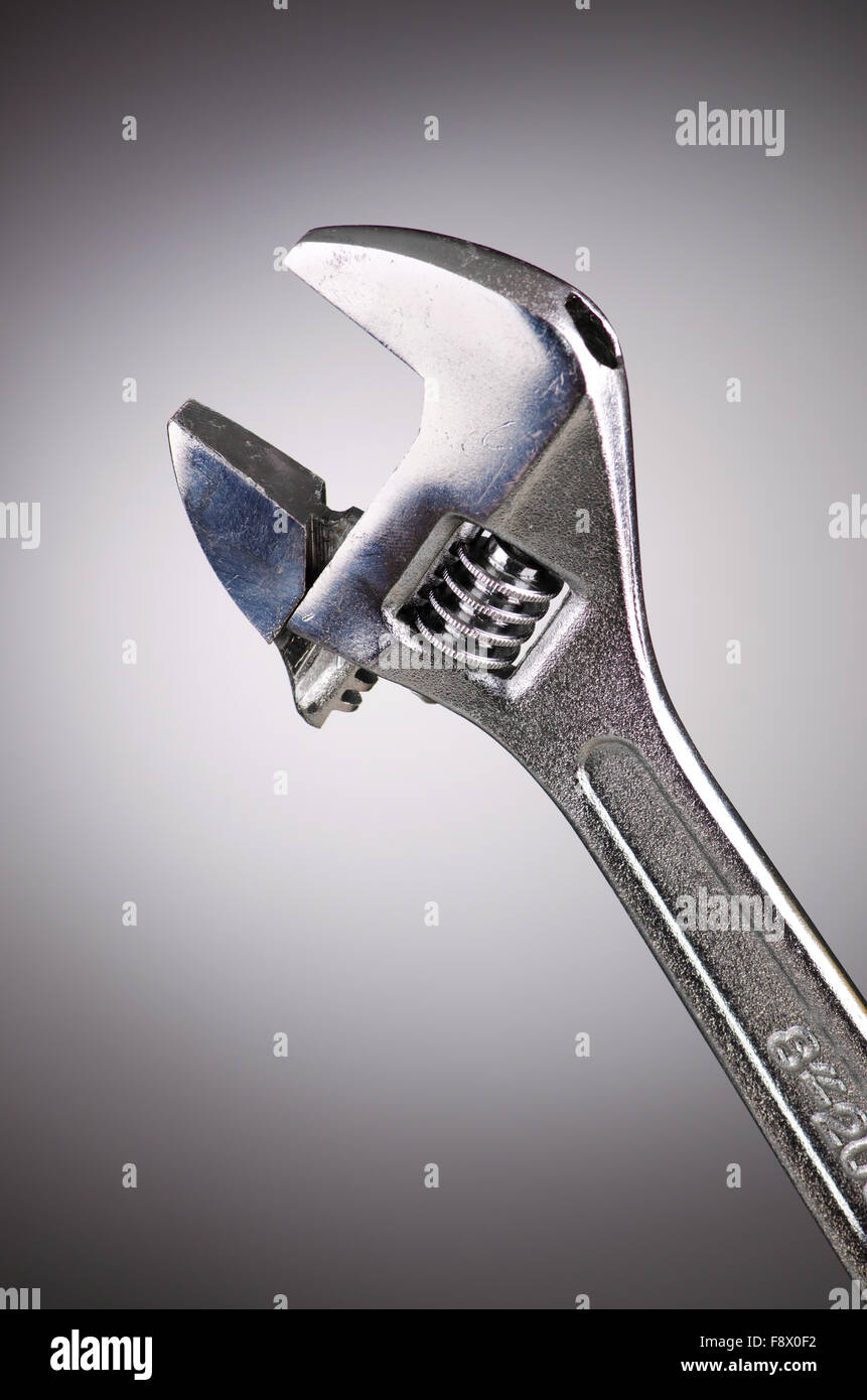 Wrench against gradient background Stock Photo - Alamy