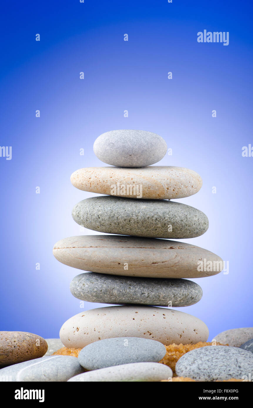 Balanced pebbles with colour background Stock Photo - Alamy