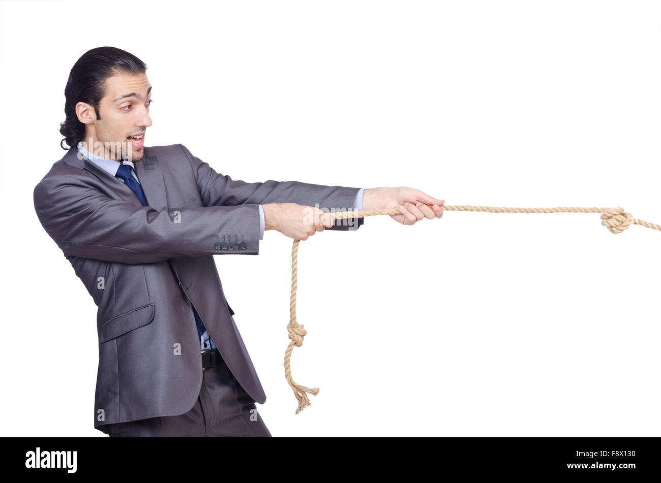 Businessman pulling rope on white Stock Photo - Alamy