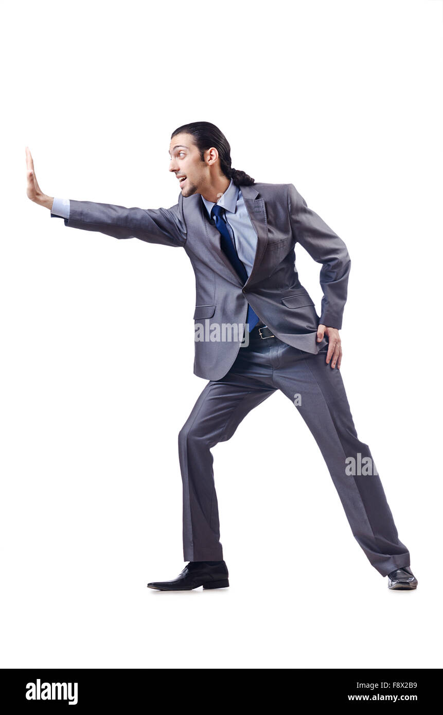 Young businessman pushing invisible obstacles Stock Photo - Alamy