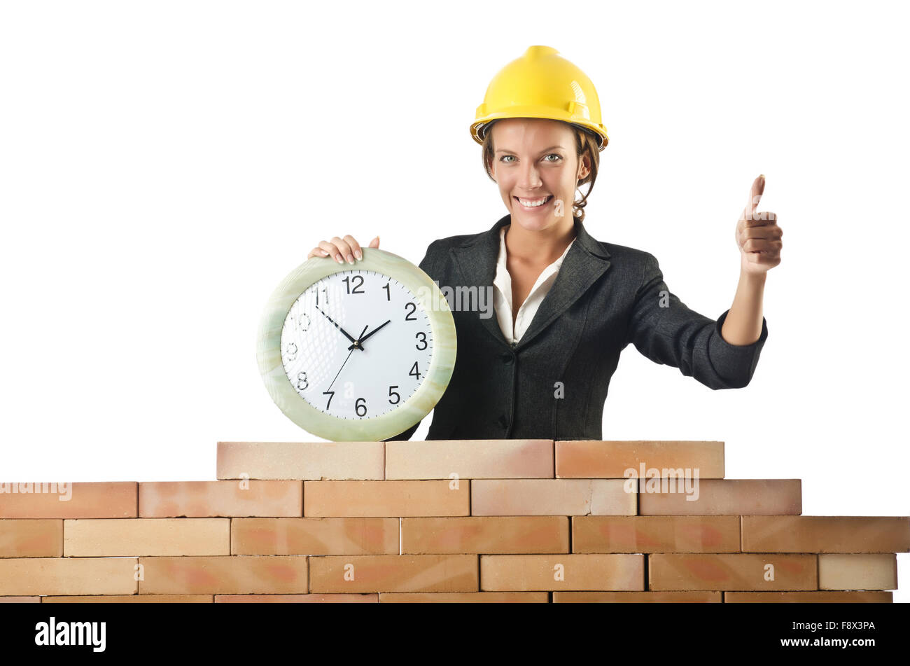 Female builder and clock on white Stock Photo - Alamy