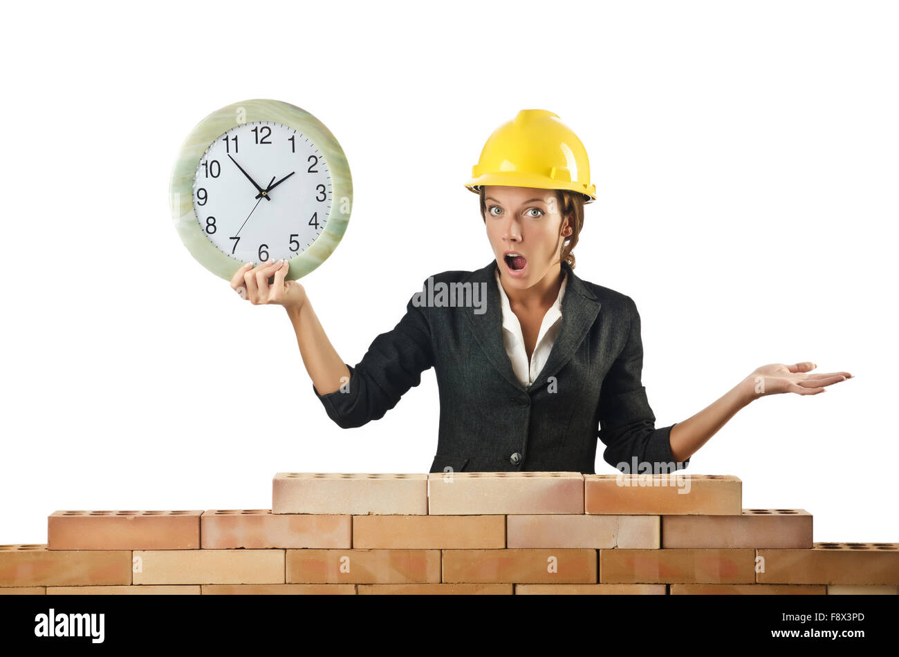 Female builder and clock on white Stock Photo - Alamy