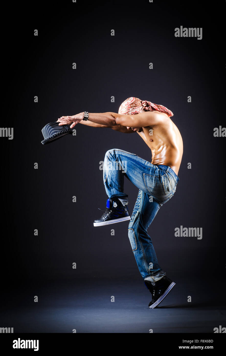 Dancer dancing in dark room Stock Photo - Alamy