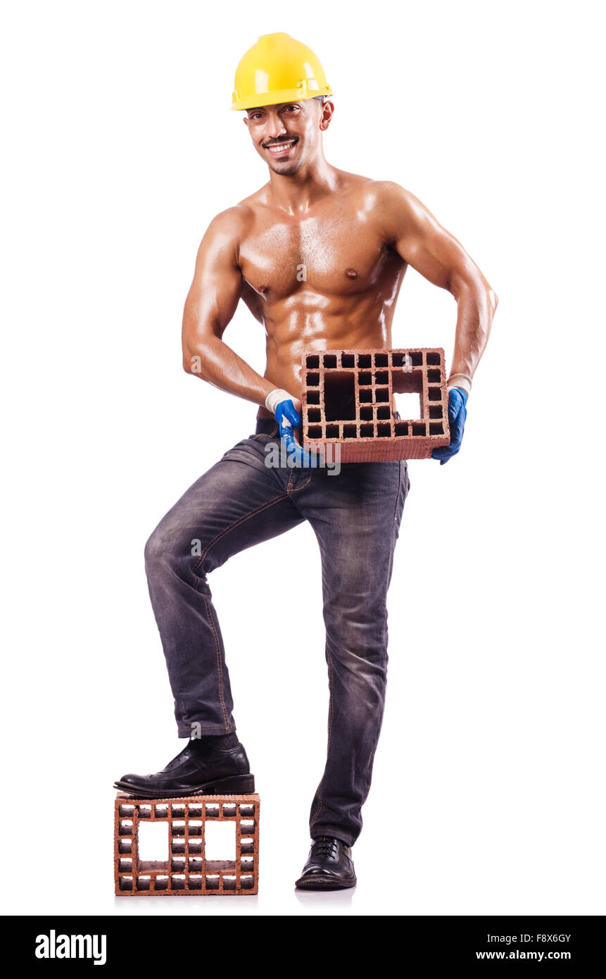 Muscular builder with bricks on white Stock Photo - Alamy