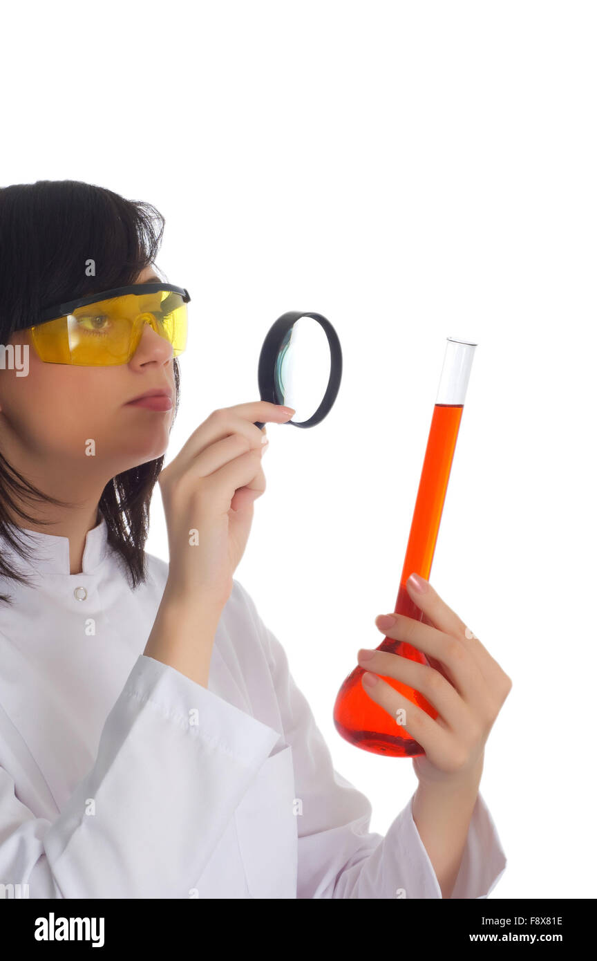 Female scientist looking at tube through magnifying lens Stock Photo ...