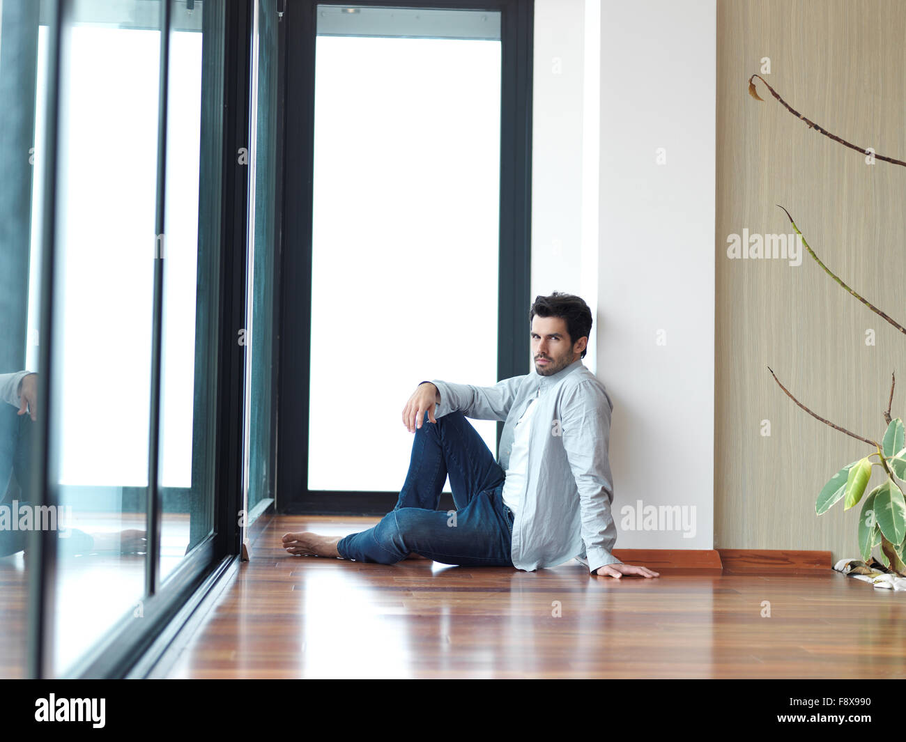 relaxed young man drink first morning coffee at modern home indoors ...