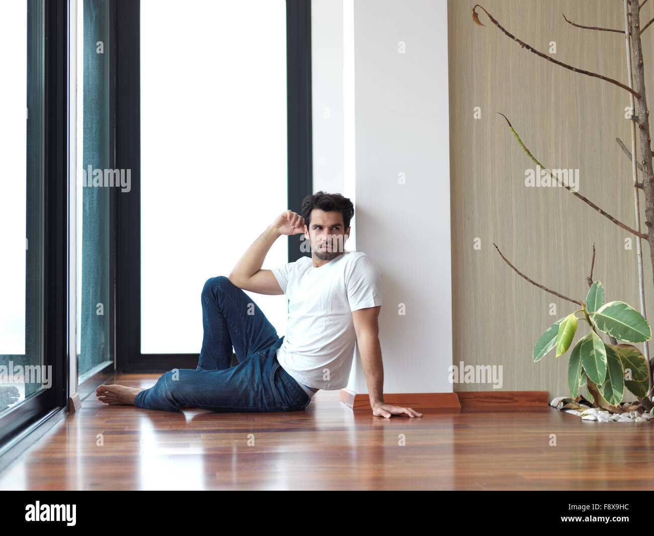 relaxed young man drink first morning coffee at modern home indoors ...