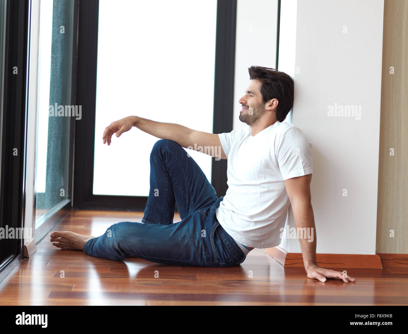 relaxed young man drink first morning coffee at modern home indoors ...