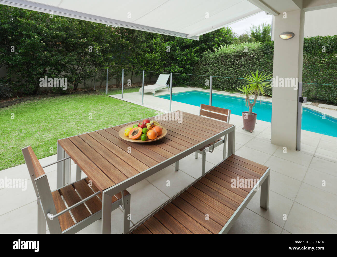 Modern suburban backyard with table setting and swimming pool Stock ...