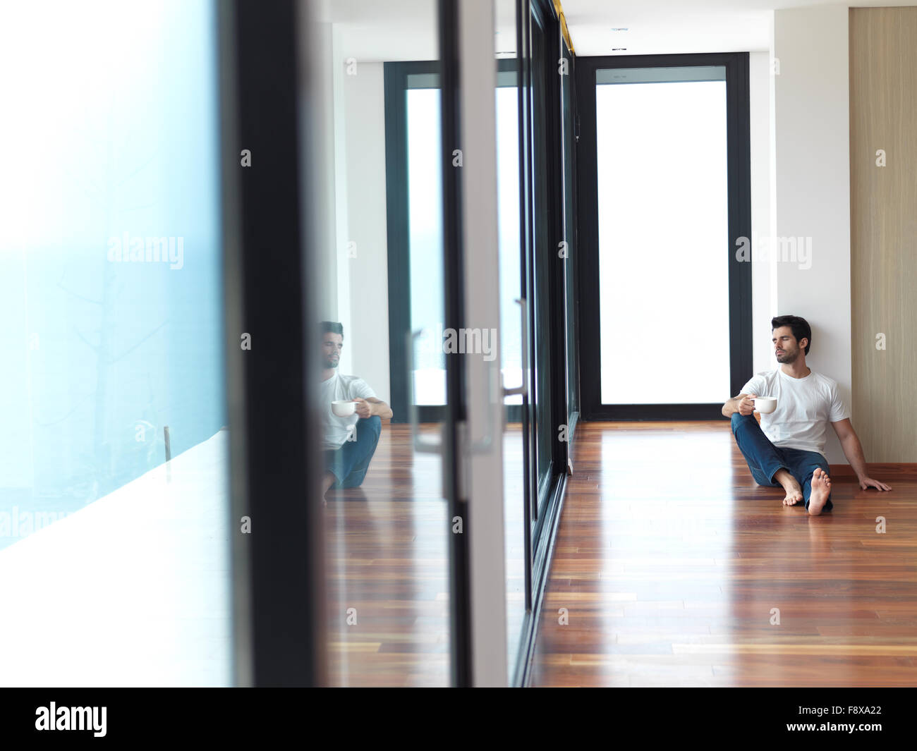 relaxed young man drink first morning coffee at modern home indoors ...