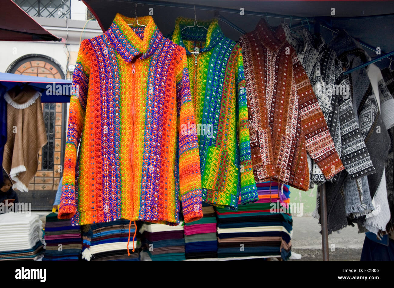 Colorful woven jackets on display in marketplace in Otavalo,Ecuador ...