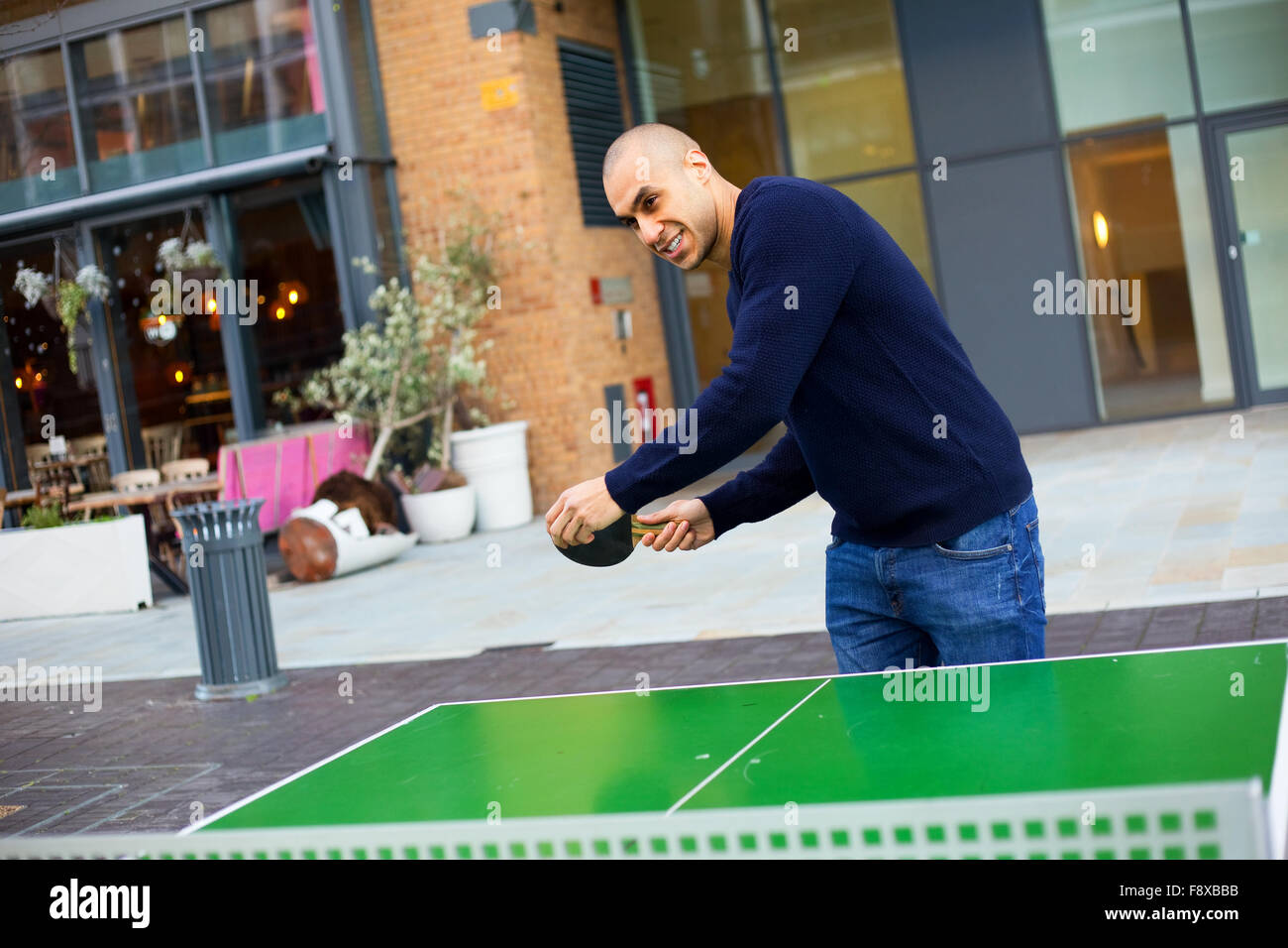 young man playing ping pong Stock Photo - Alamy