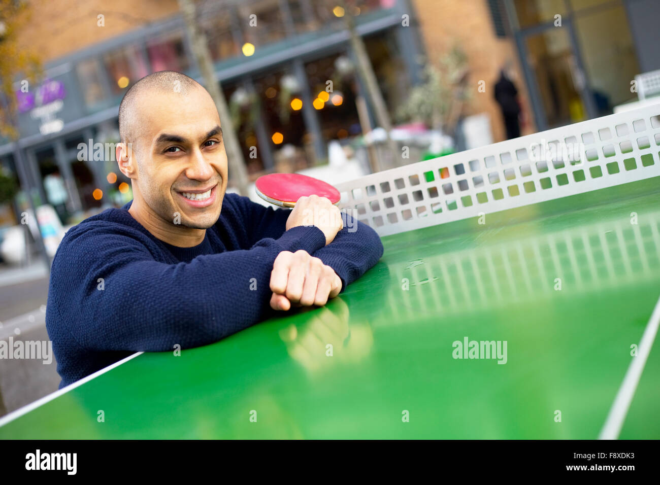 young man posing holding a table tennis racket Stock Photo - Alamy