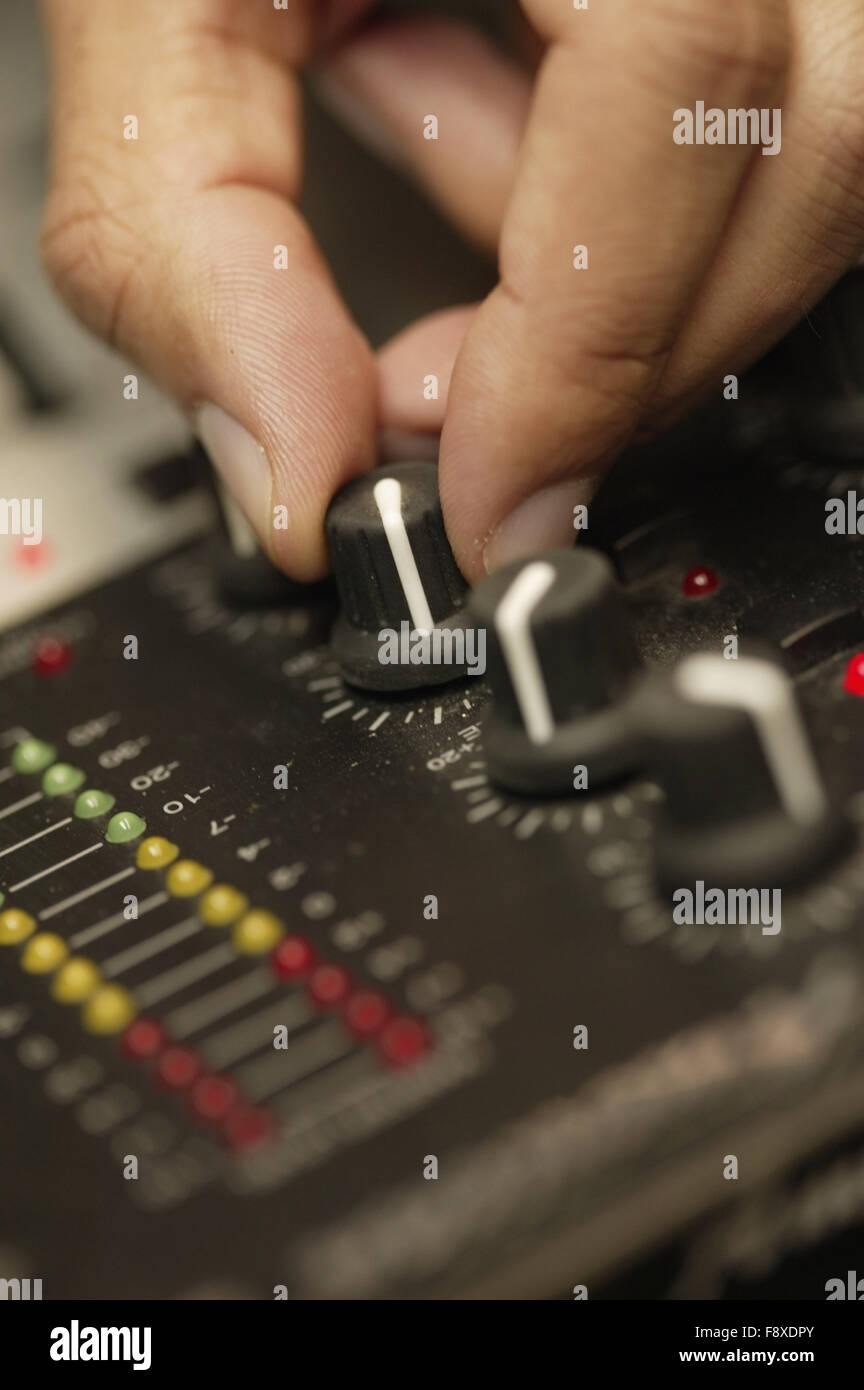 Disc Jockey Turning Dial on Sound Board Stock Photo - Alamy