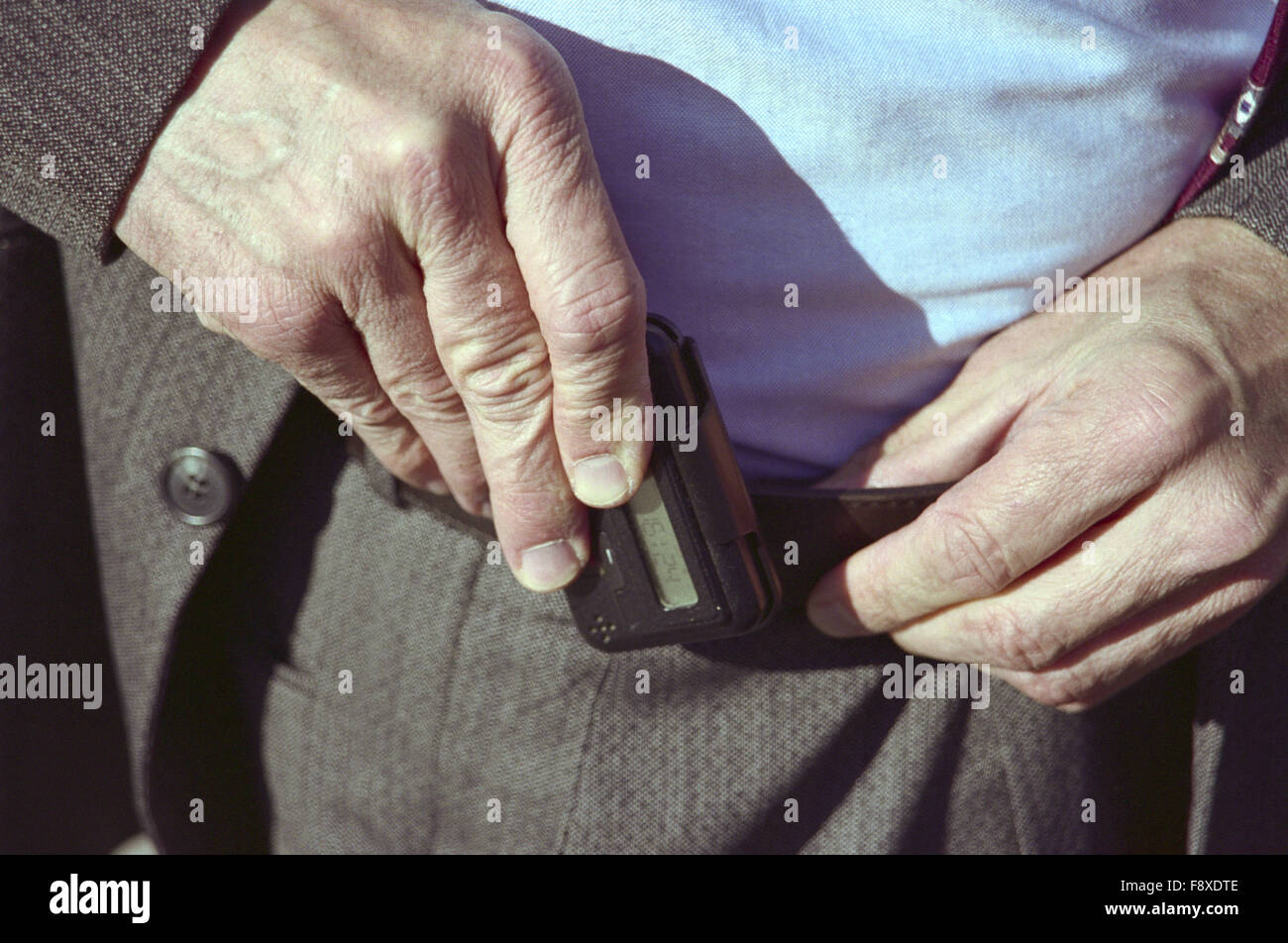 Man Clipping Pager to Trousers Stock Photo - Alamy