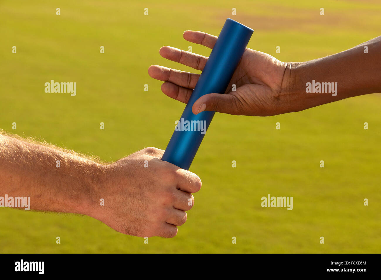Hands Passing Baton at Sporting Event Stock Photo - Alamy