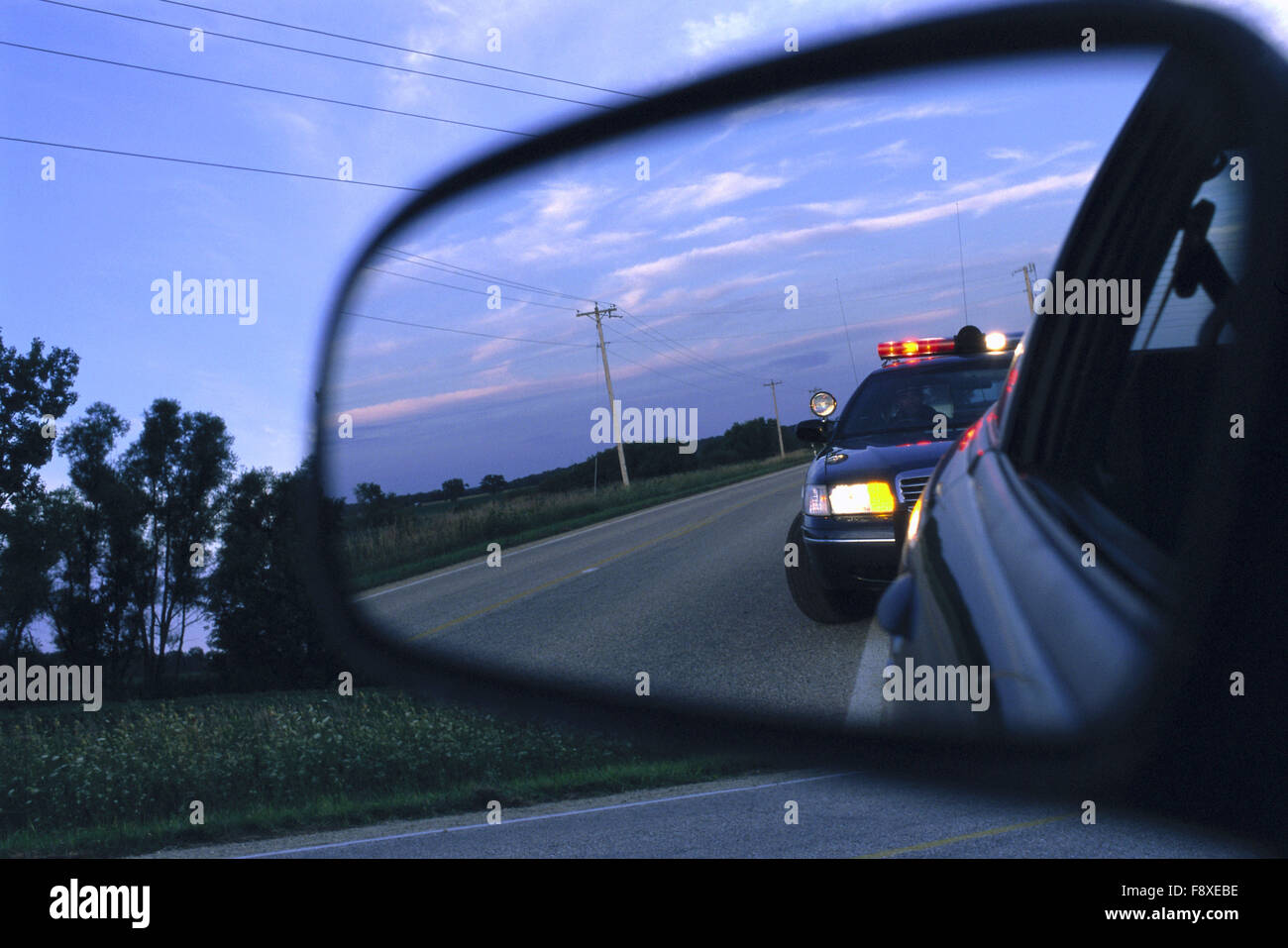 Police Car In Side View Mirror Stock Photo - Alamy