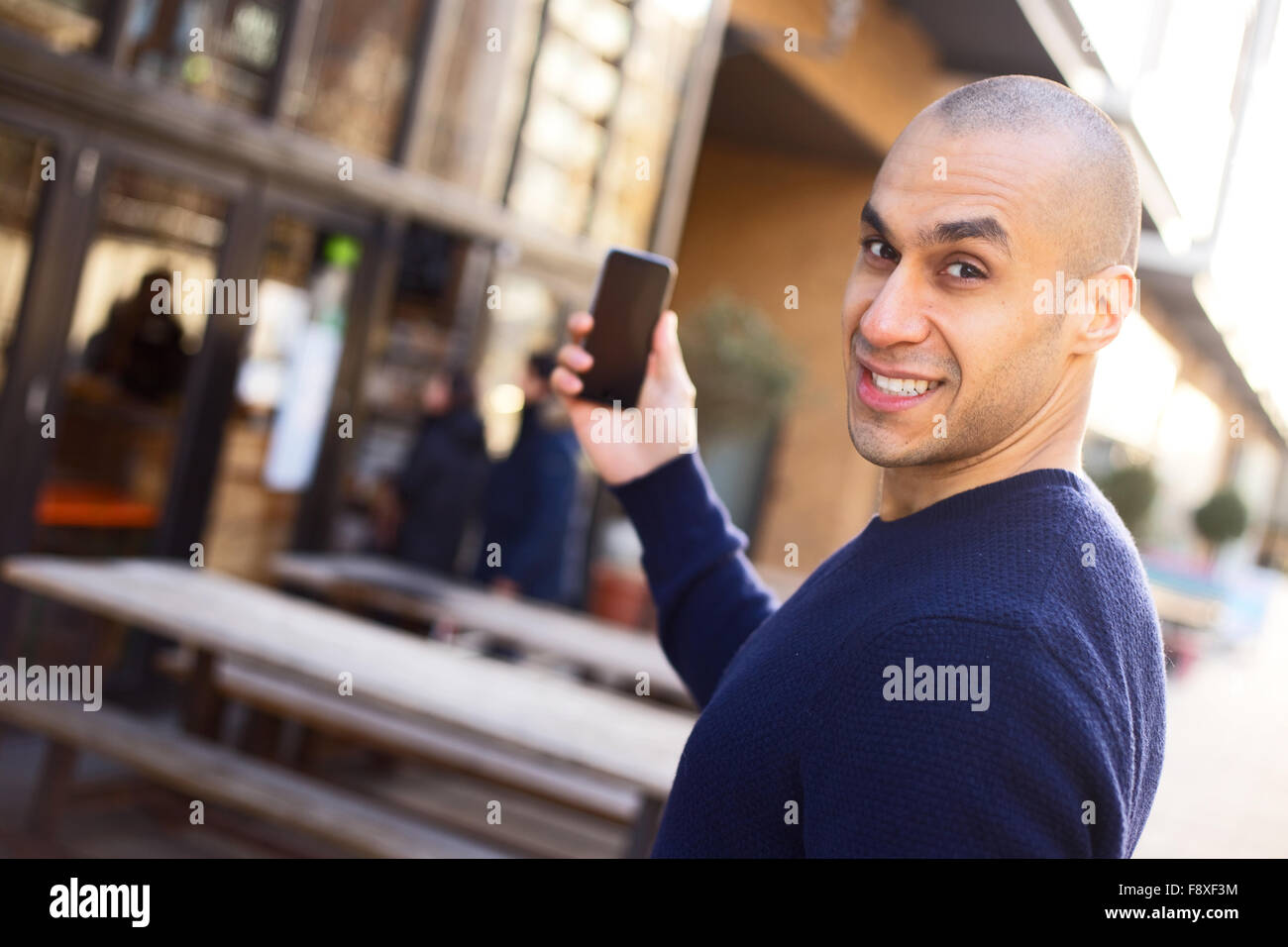Guy holding mobile handset hi-res stock photography and images - Alamy