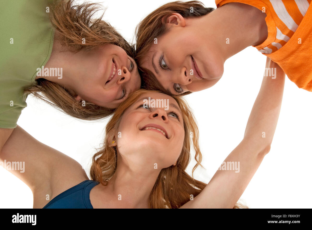 Three happy friends looking at each other Stock Photo - Alamy