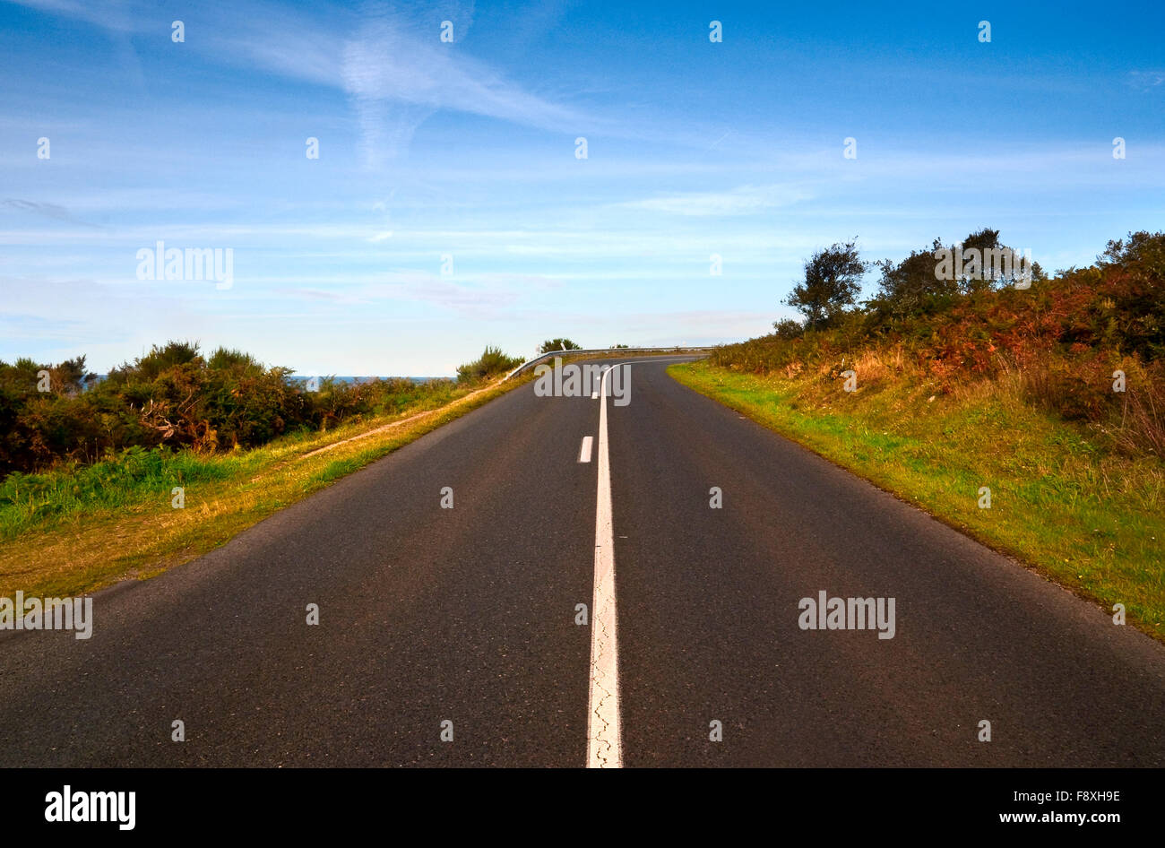 road in evening lights on the cliff - right turning Stock Photo - Alamy