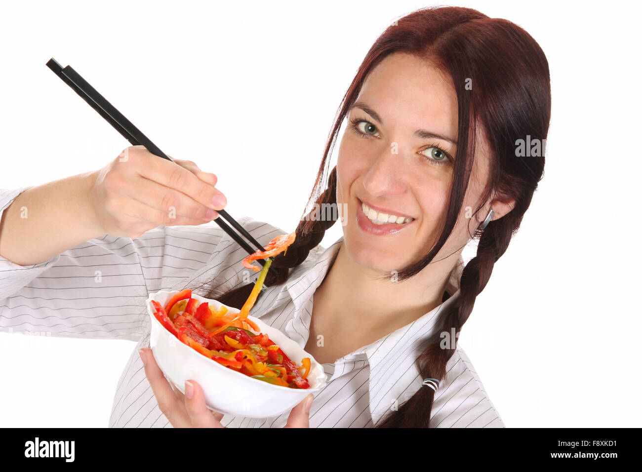 Beautiful woman eating with chopsticks Stock Photo - Alamy