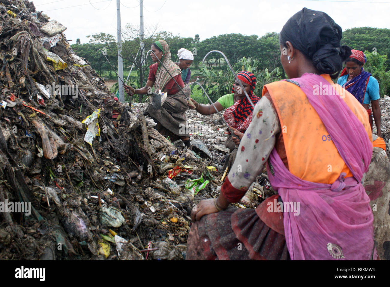 Male and Female waste pickers pick the non- biodegradable waste to be ...