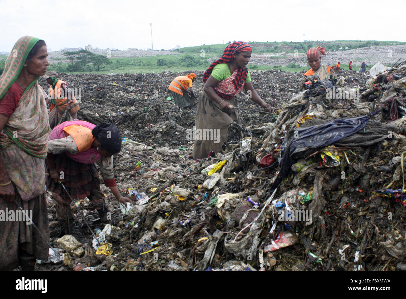 Male and Female waste pickers pick the non- biodegradable waste to be ...