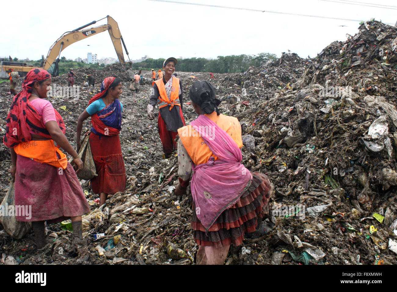 Male and Female waste pickers pick the non- biodegradable waste to be ...
