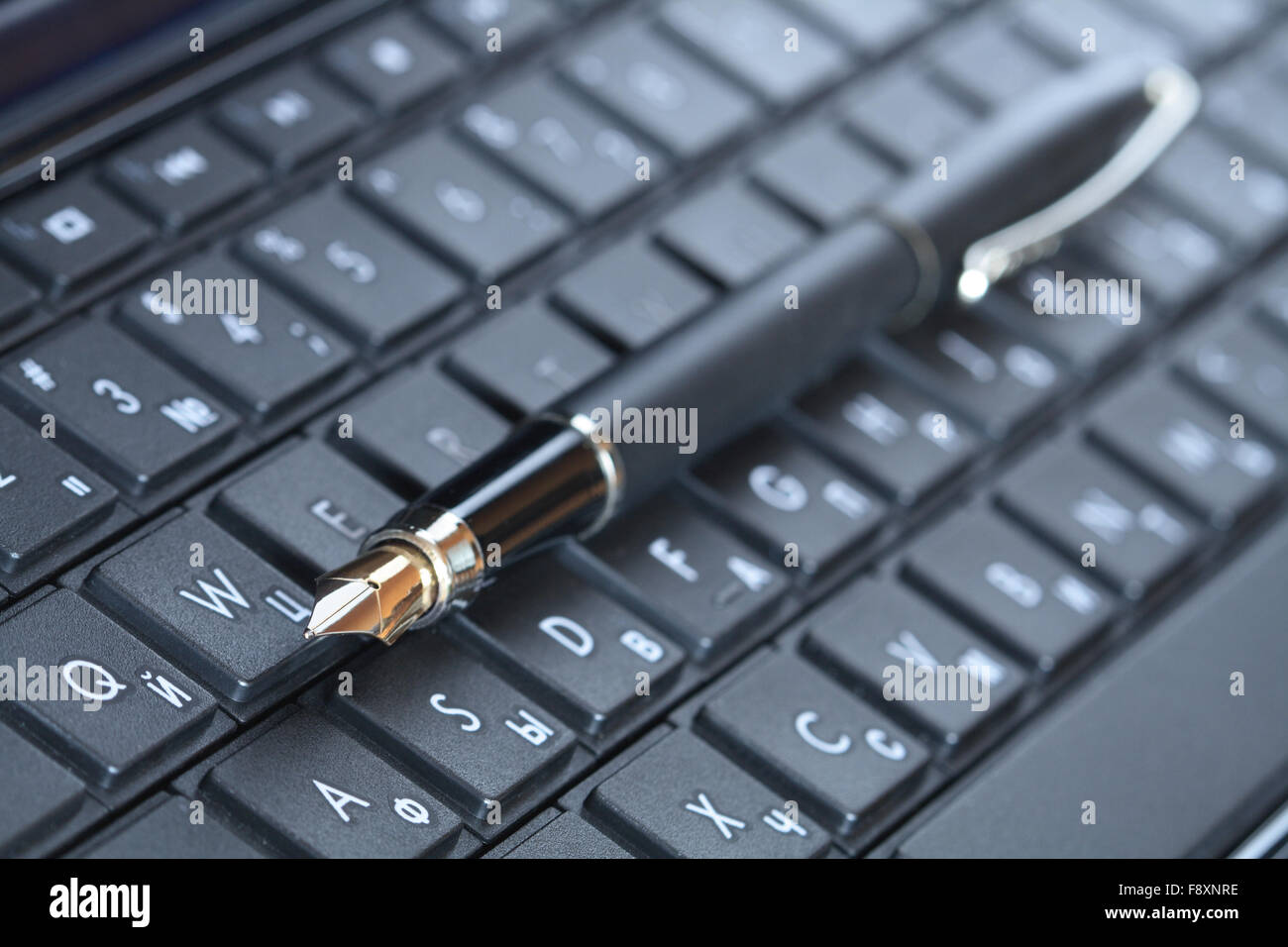 Pen On Computer Keyboard Stock Photo - Alamy