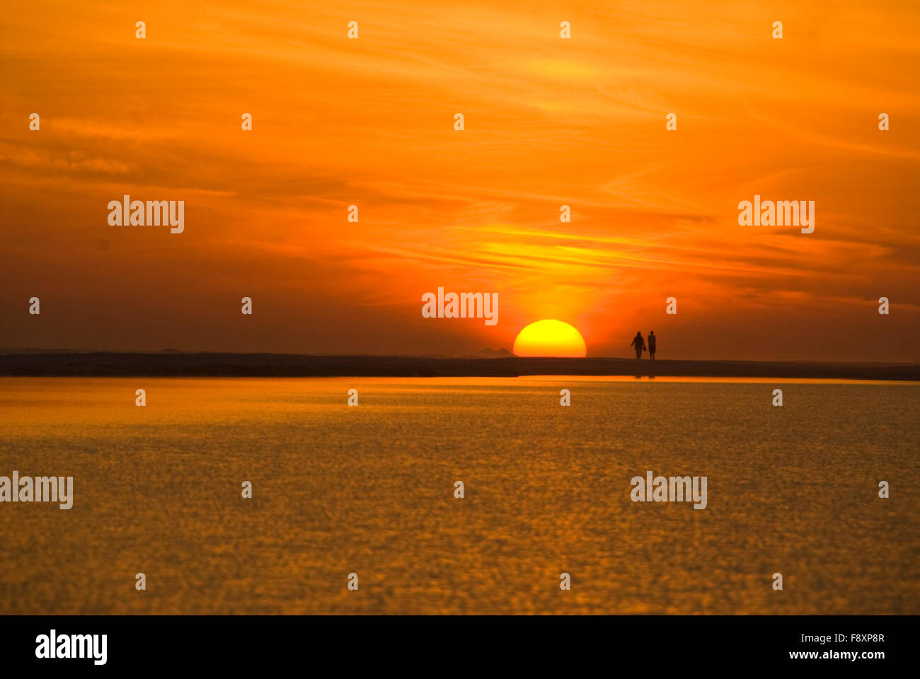 Couple Walk in Sunset Stock Photo - Alamy