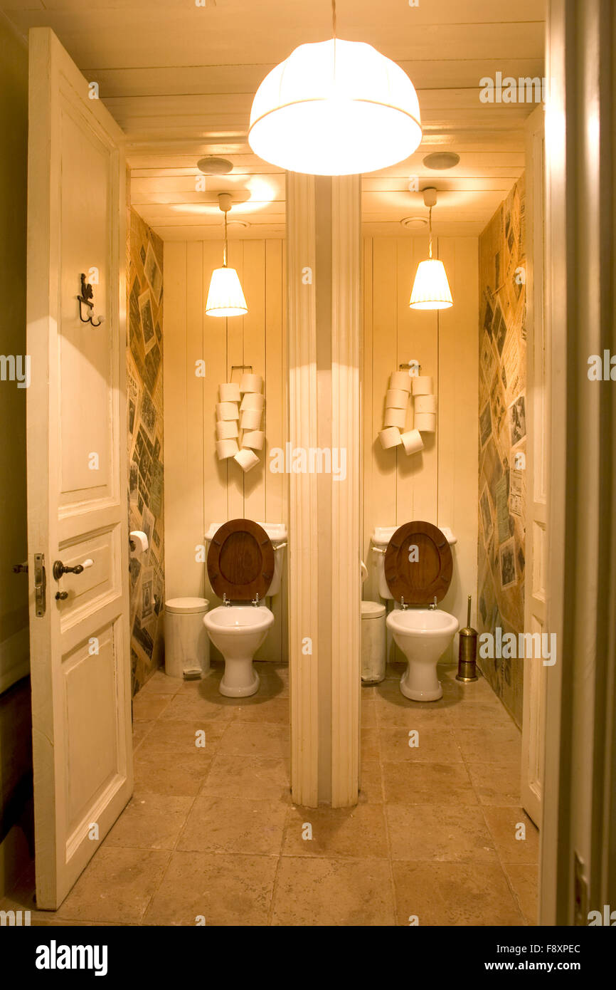 bathroom in public place with two toilets Stock Photo - Alamy