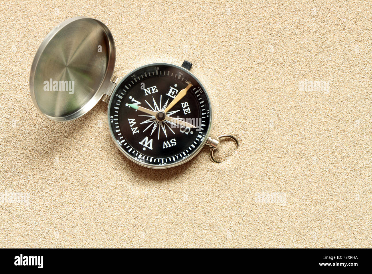 Compass On Sand Stock Photo - Alamy