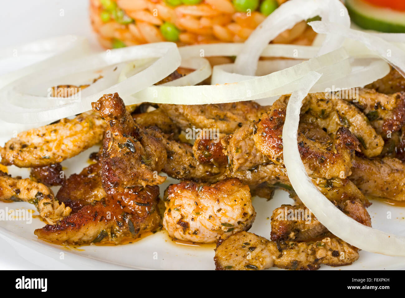 gyros meat, onion rings and rice Stock Photo - Alamy
