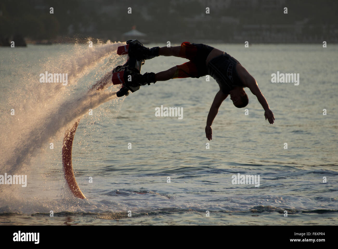 Flyboarder diving into sea with arms out Stock Photo - Alamy