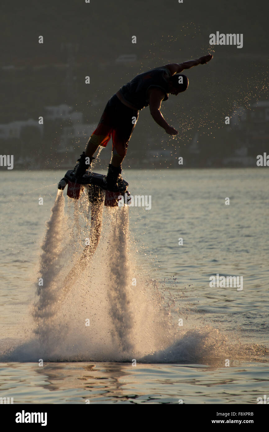 Flyboarder dripping with spray backlit before dive Stock Photo - Alamy