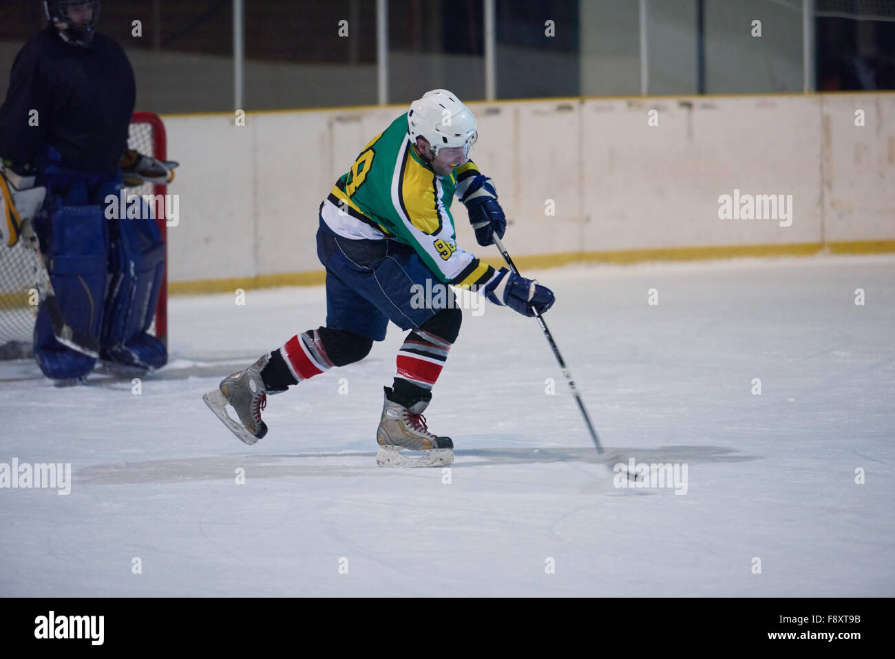 ice hockey player in action kicking with stick Stock Photo - Alamy