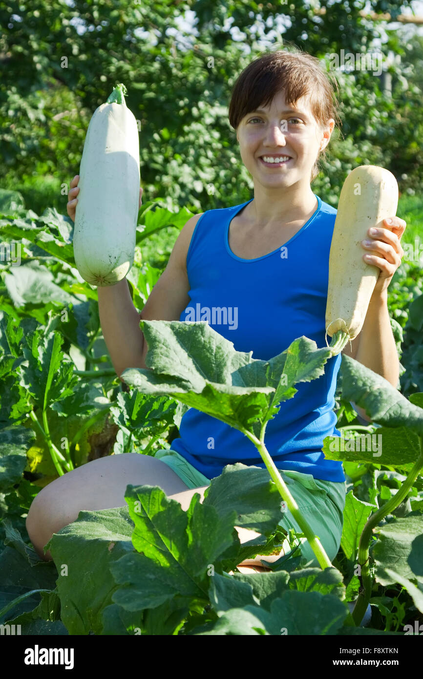 young woma is picking vegetable marrow in field Stock Photo - Alamy