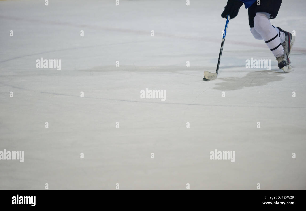 ice hockey player in action kicking with stick Stock Photo - Alamy